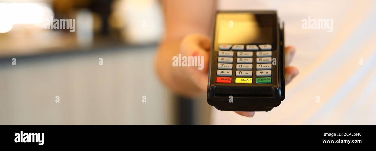Man holds commercial portable banking terminal Stock Photo - Alamy