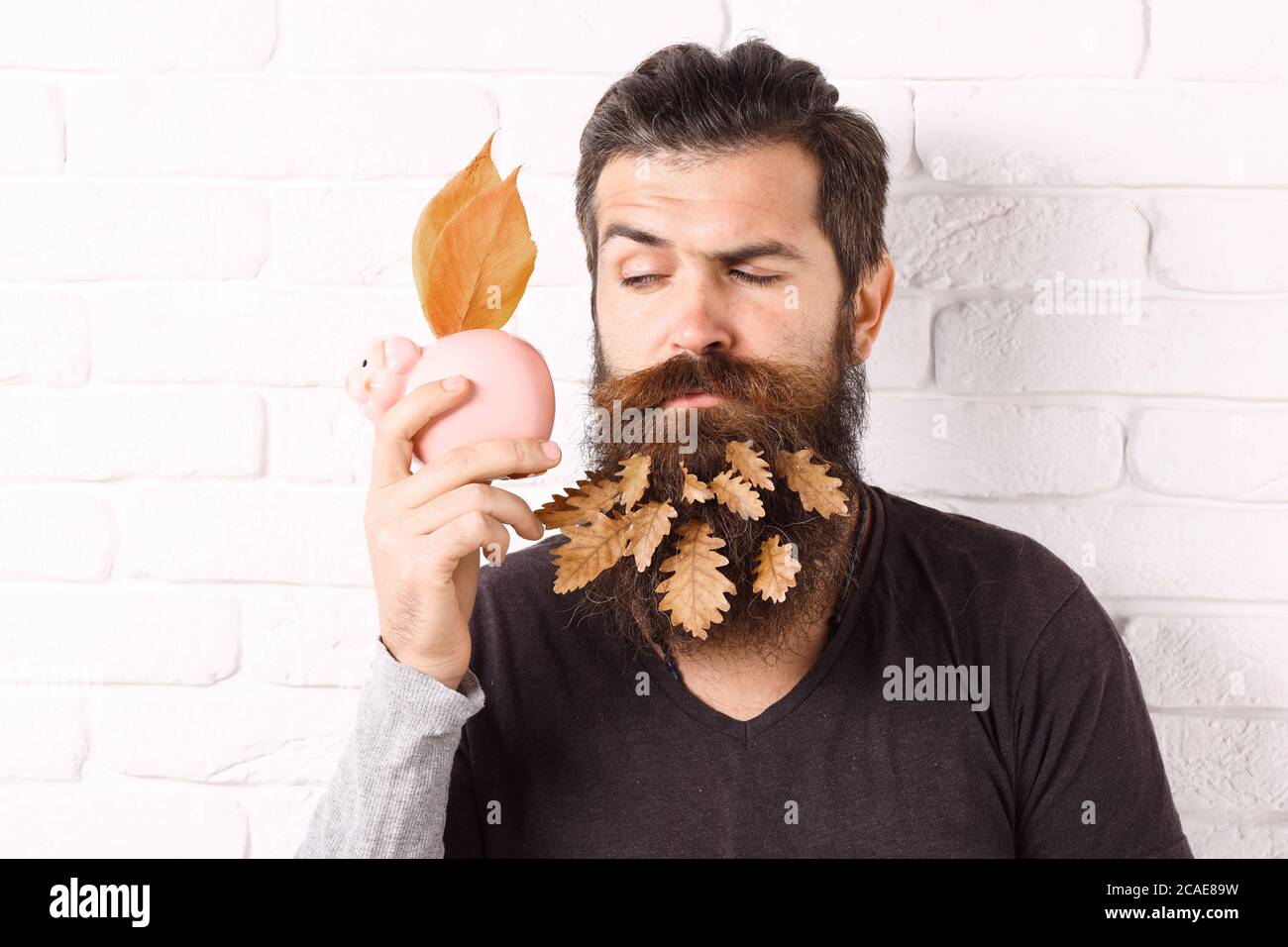 handsome bearded man with stylish mustache and autumn yellow leaves in ...