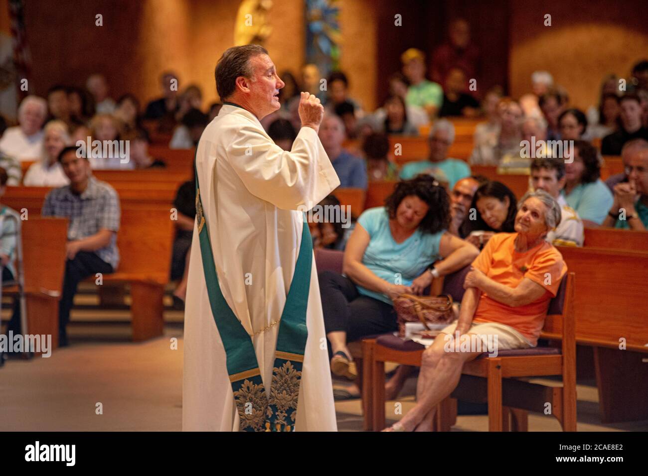 Wearing a white robe before an appreciative congregation, an ...