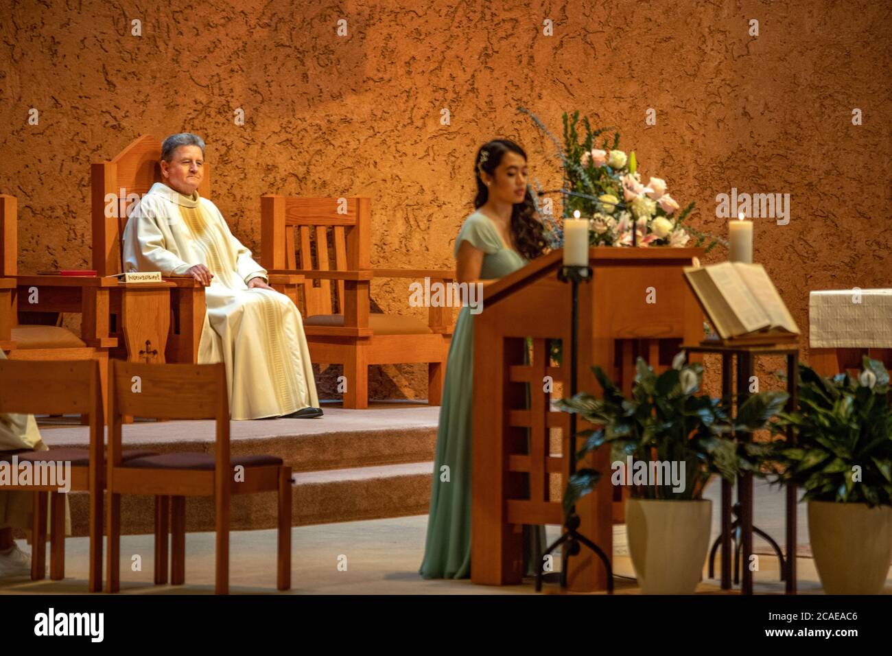 The robed monsignor of a Southern California Catholic Church listens as ...