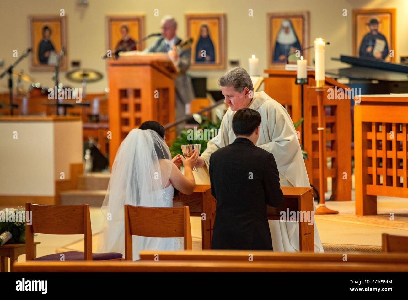 The monsignor of a Southern California Catholic church offers communion ...