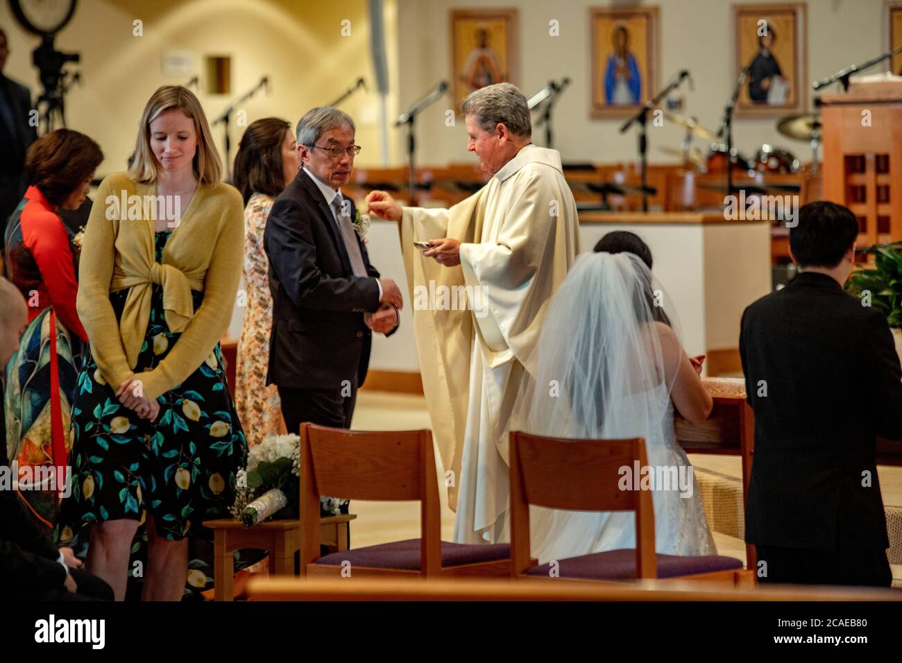 The monsignor of a Southern California Catholic church offers communion ...