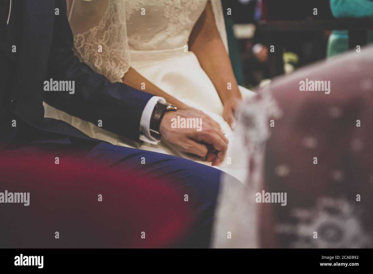 Closeup photo of the groom holding the hand of bride during wedding ...