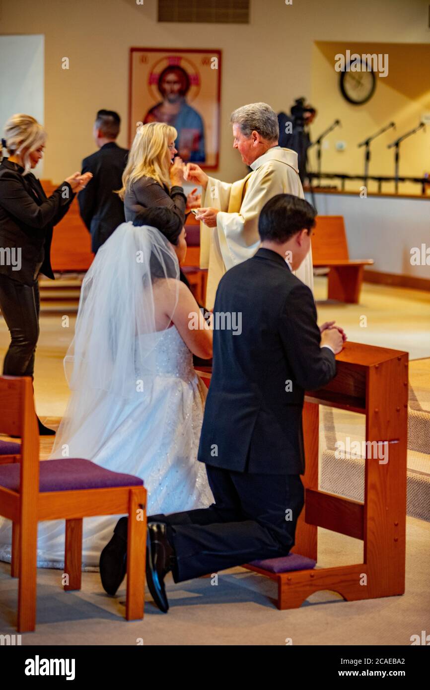 Priest offering communion hi-res stock photography and images - Alamy