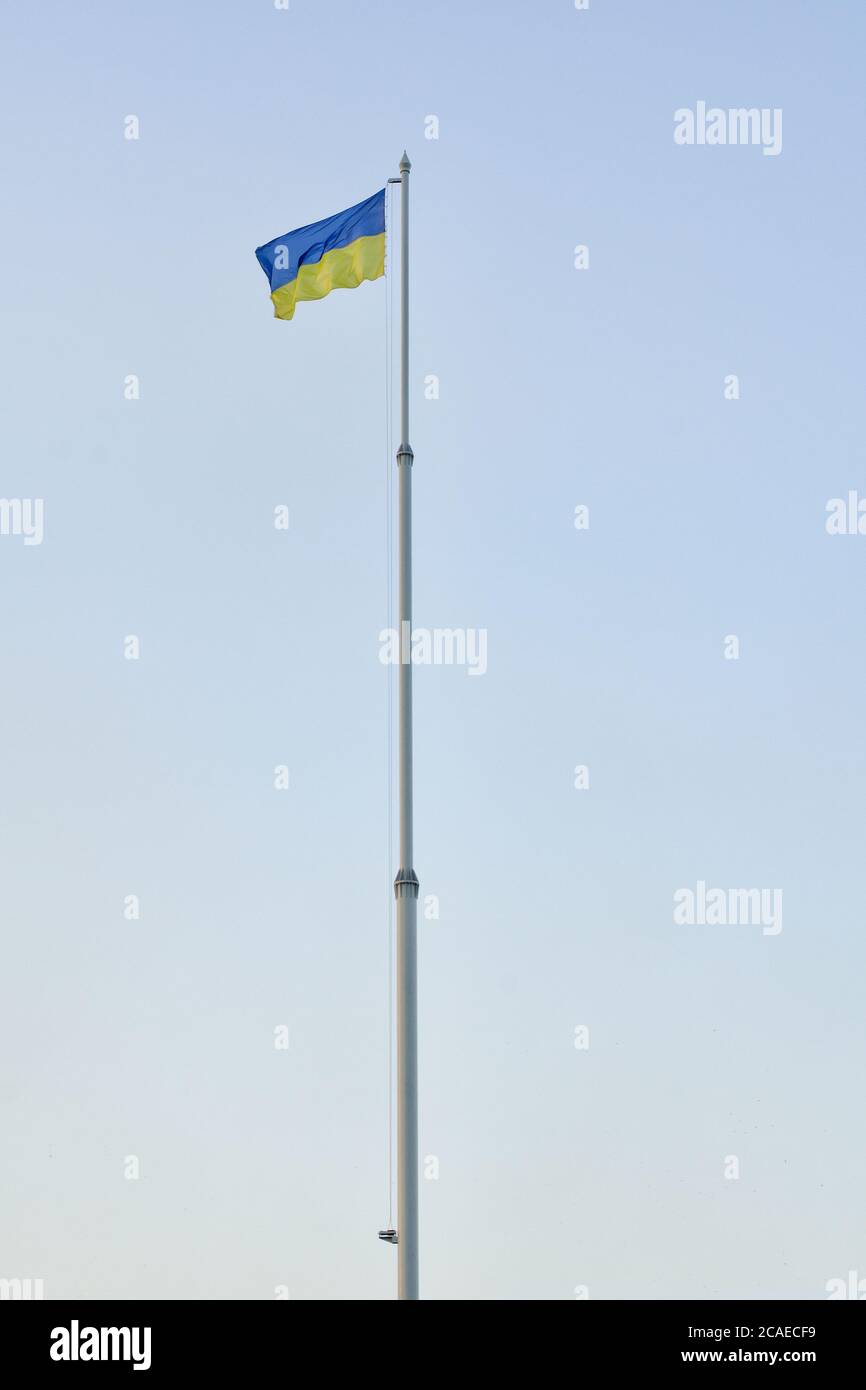 Flag of Ukraine on flagpole against the blue sky, vertical frame Stock ...