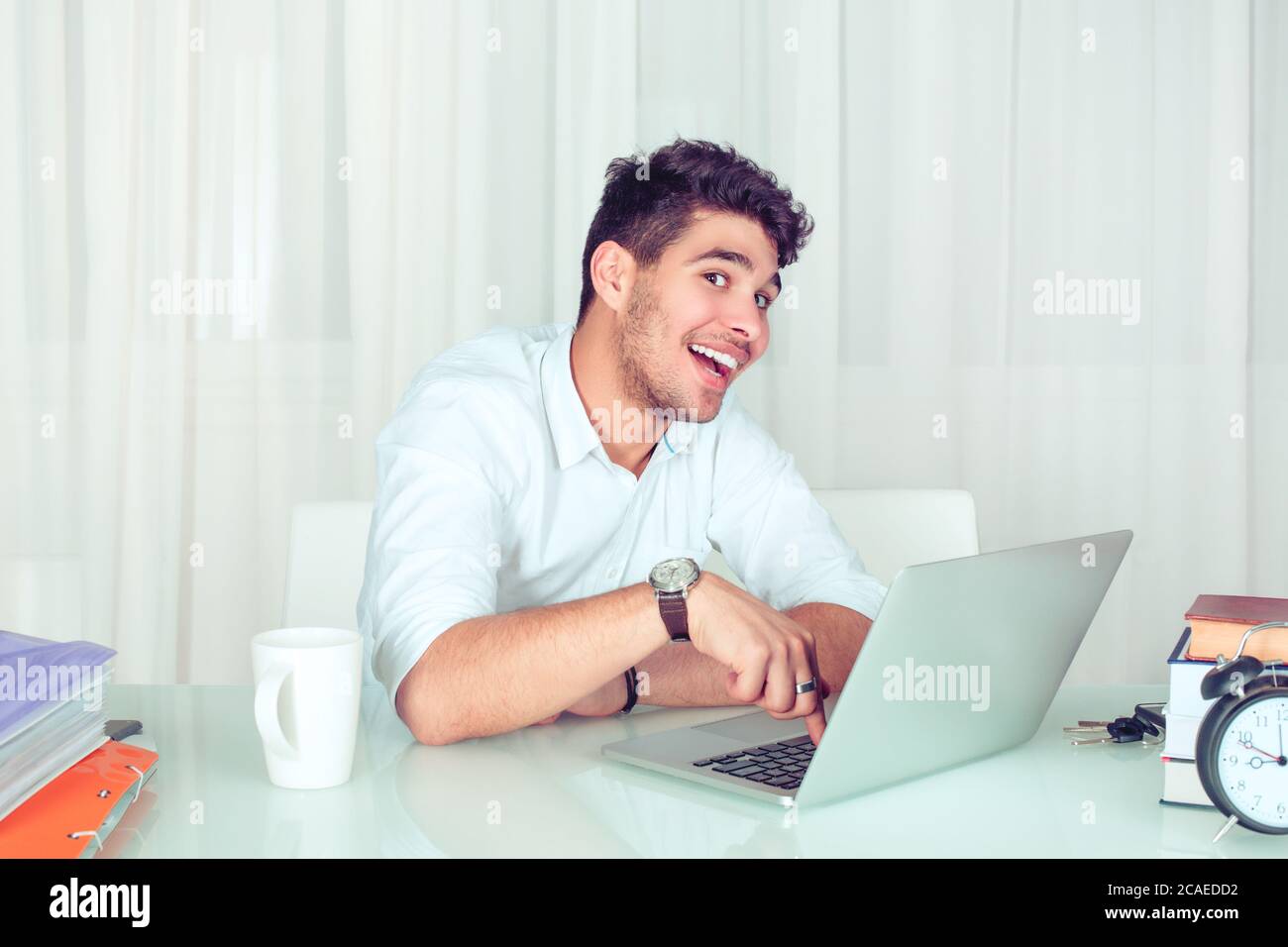 Happy adult man looking excitedly at camera while pushing enter button ...