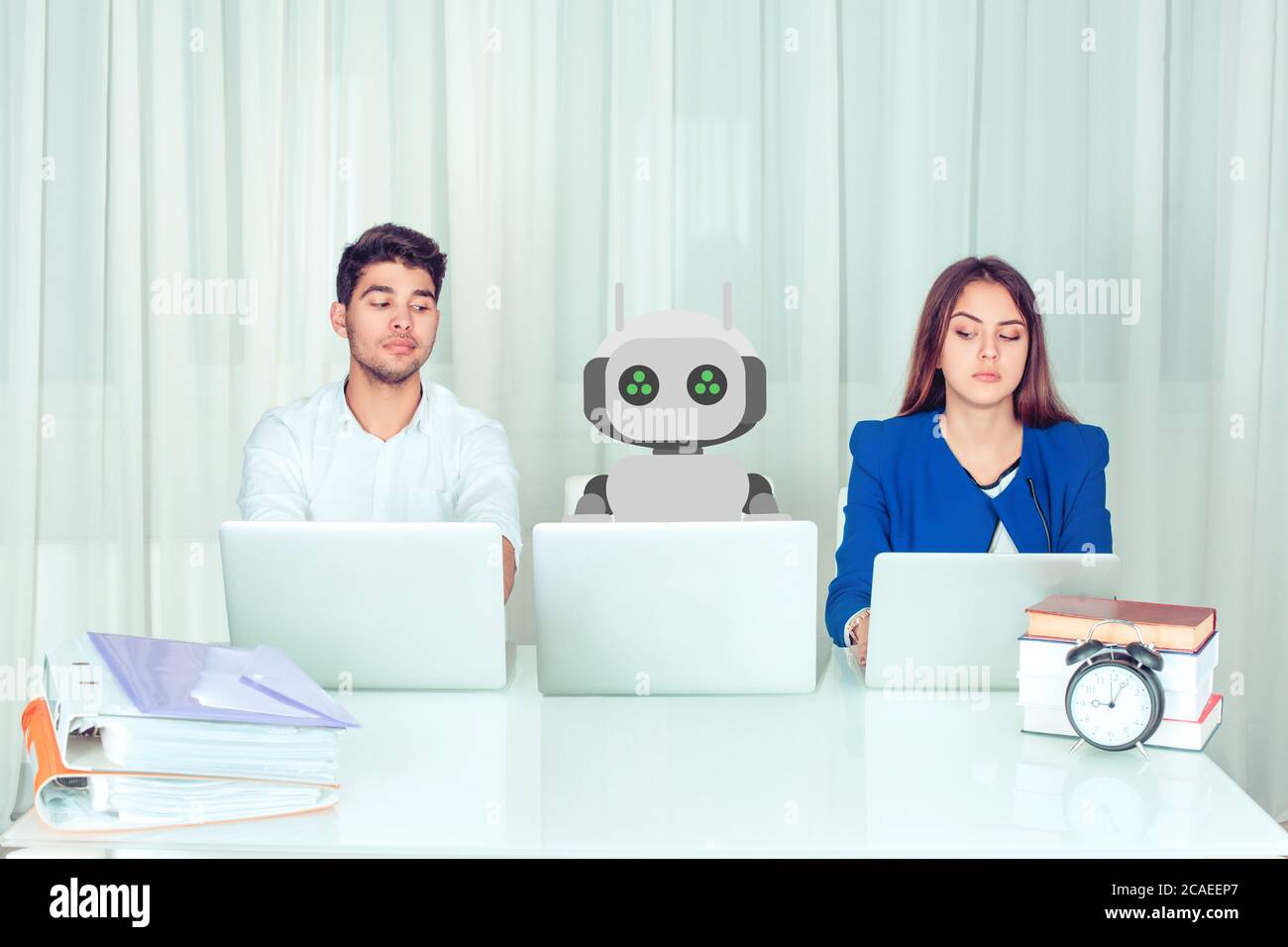 Young man and woman corporate employees with laptops sitting at table ...