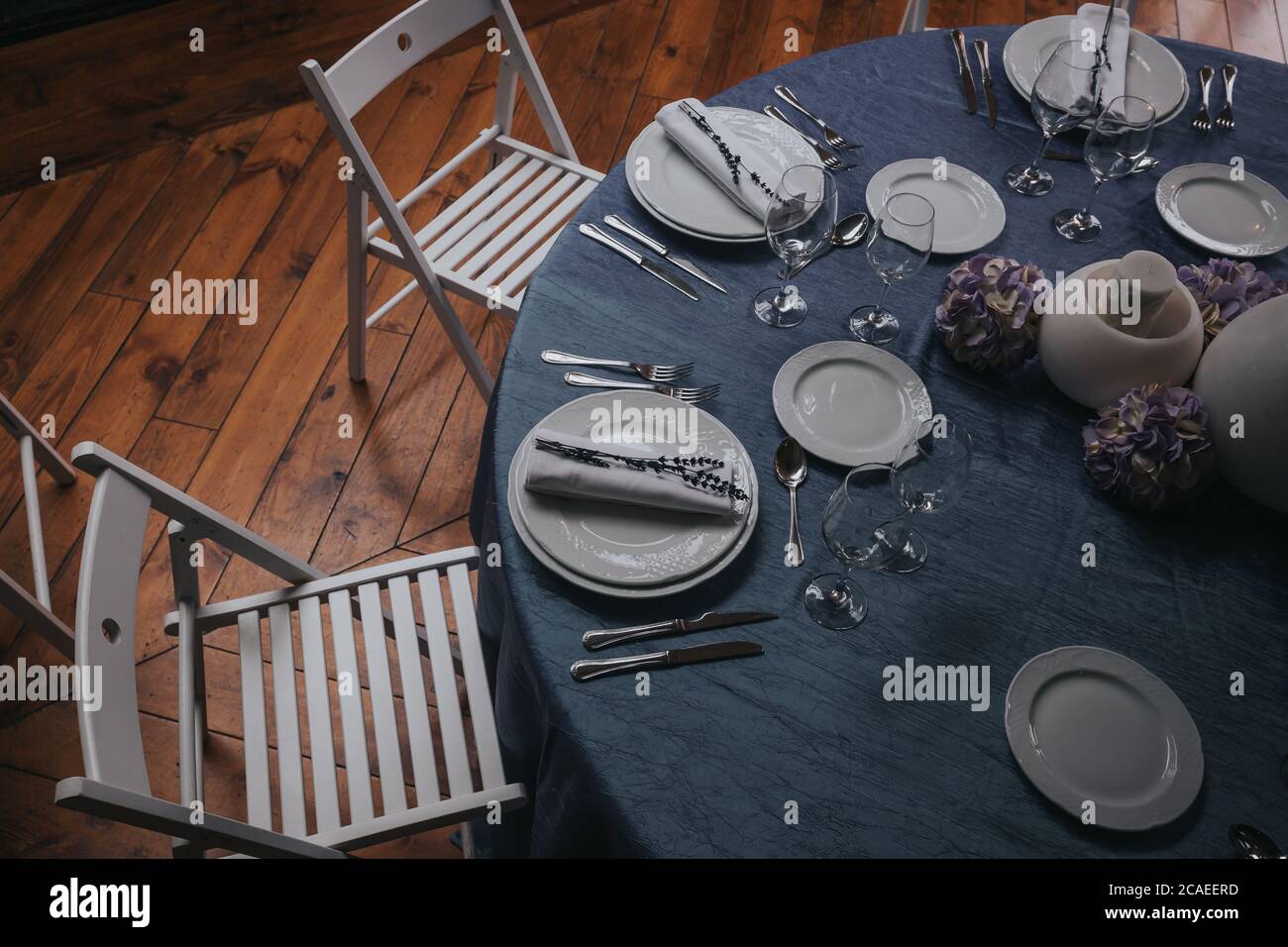 Serving tableware on a round table in a restaurant Stock Photo - Alamy
