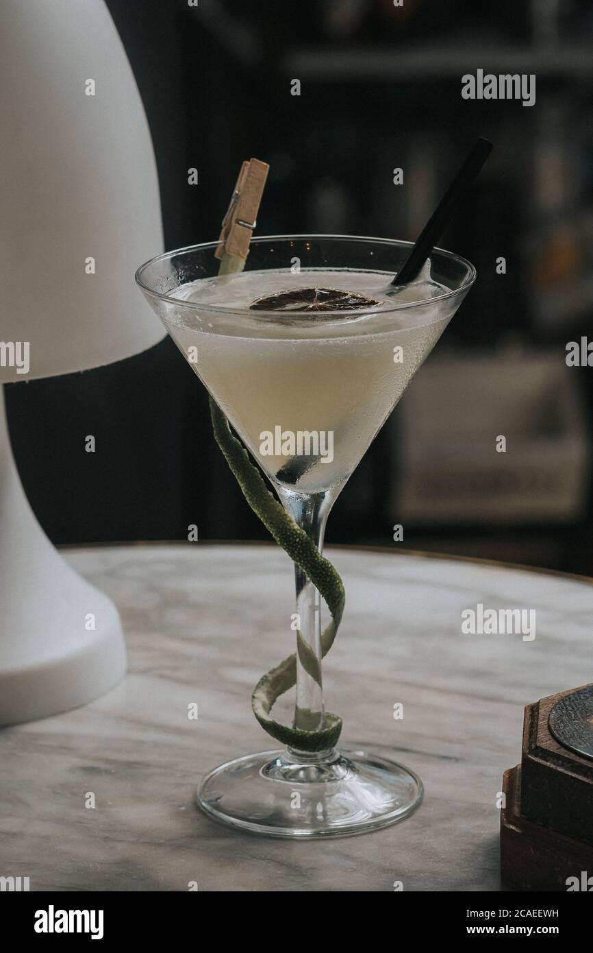 Vertical shot of a white alcoholic cocktail on a bar table Stock Photo ...