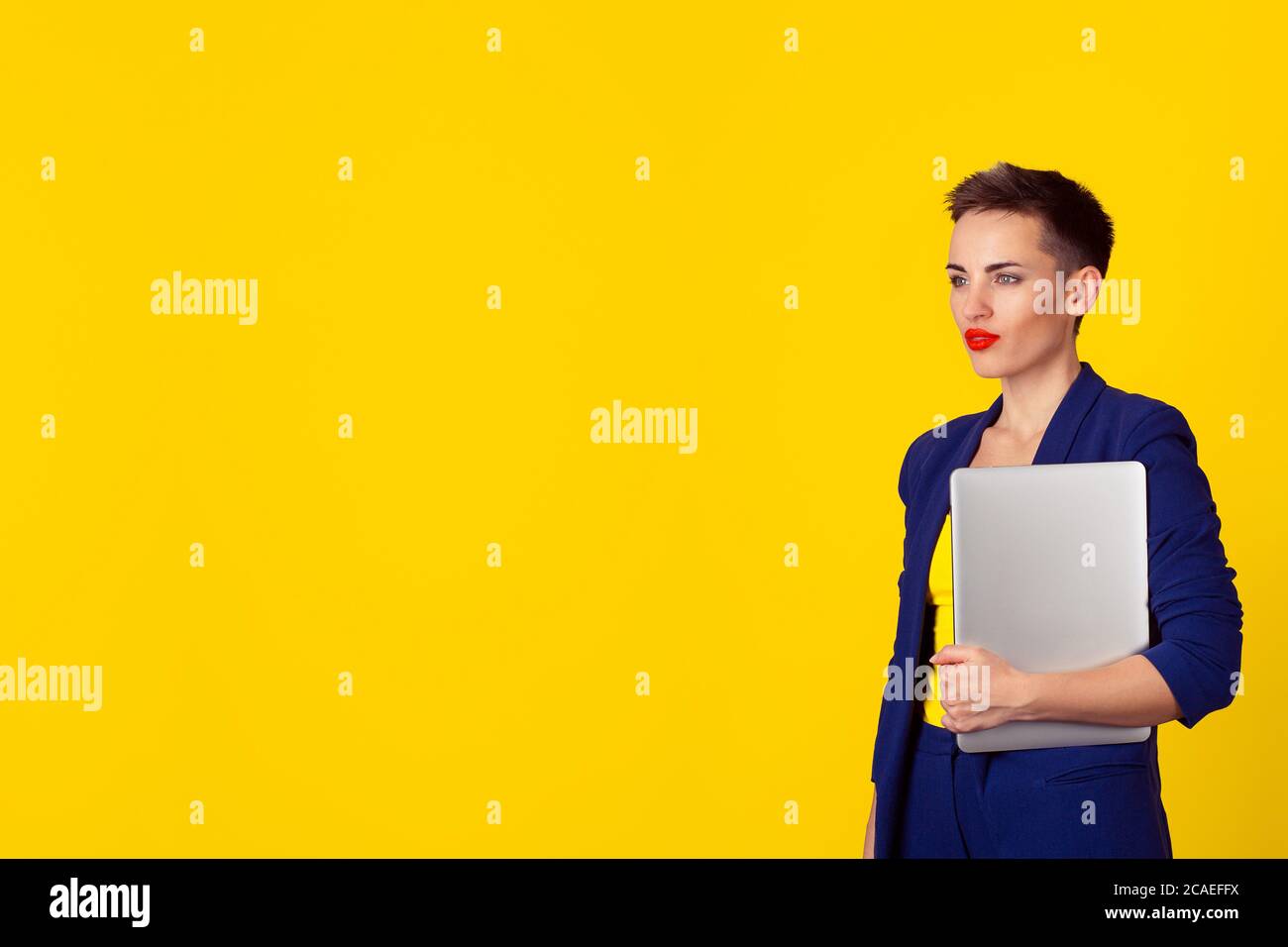 Portrait of pretty employee in side profile holding digital tablet ...