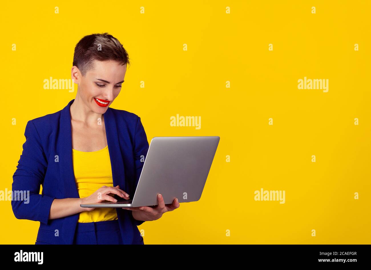 Working online. Smiling short hair woman sending emails standing with ...