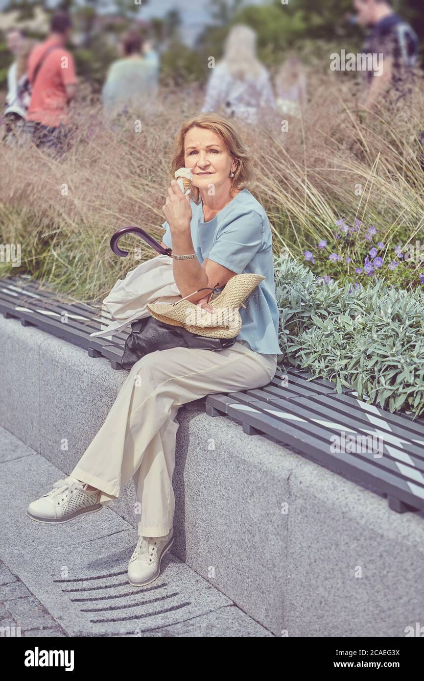 Senior white attractive woman about 62 years old is sitting on the ...