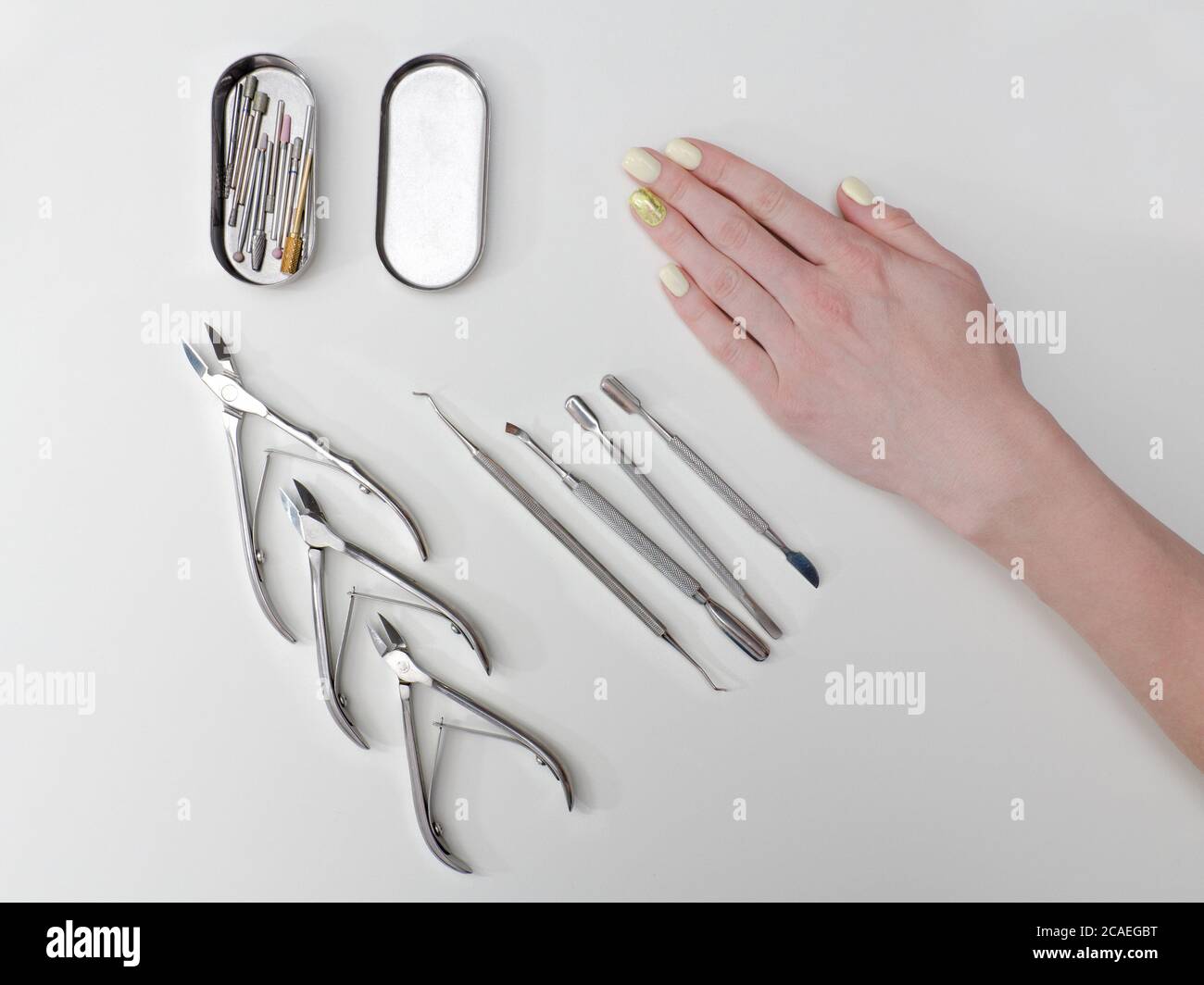 Set of tools for manicure and a female hand. White background Stock ...