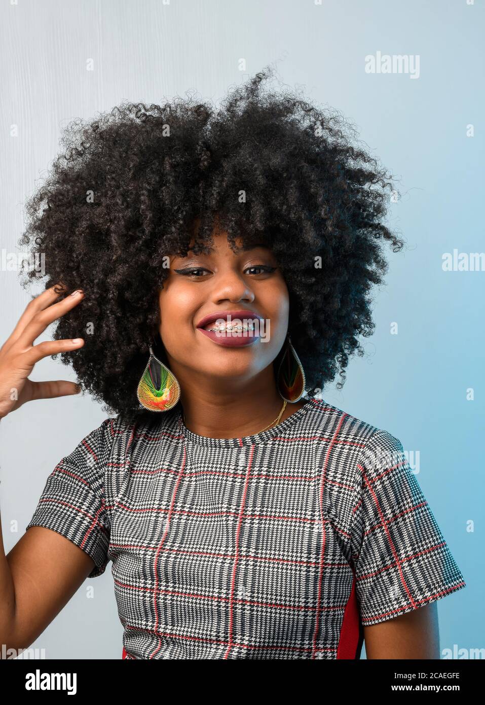 beautiful young black woman looking after her hair Stock Photo - Alamy