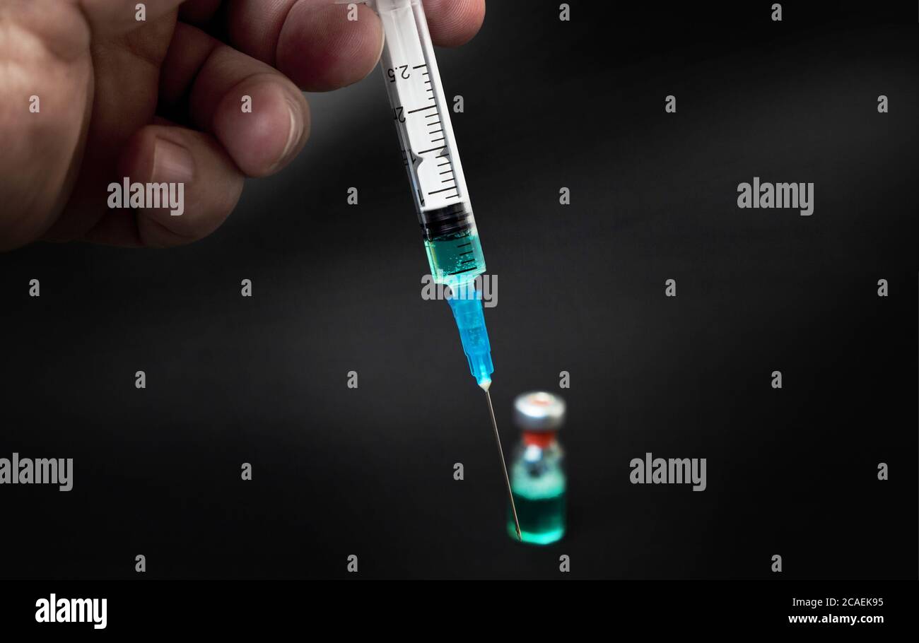 syringe isolated on black background Stock Photo - Alamy