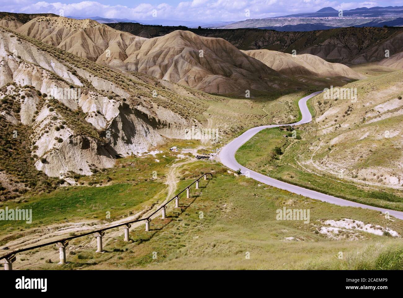 dramatic landscape of Sicily rural road crosses eroded rock formation ...