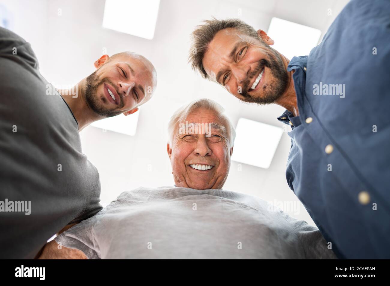 Three Generation Happy Men Standing Making Huddle Stock Photo - Alamy