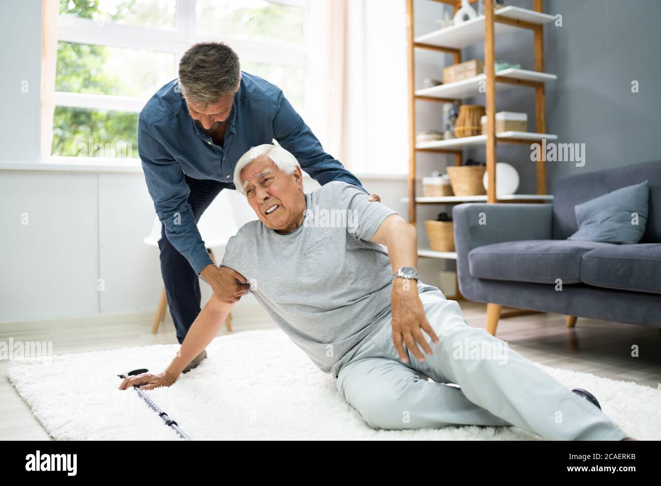 Helping Elder Senior Fallen Man After Fall Accident Stock Photo - Alamy