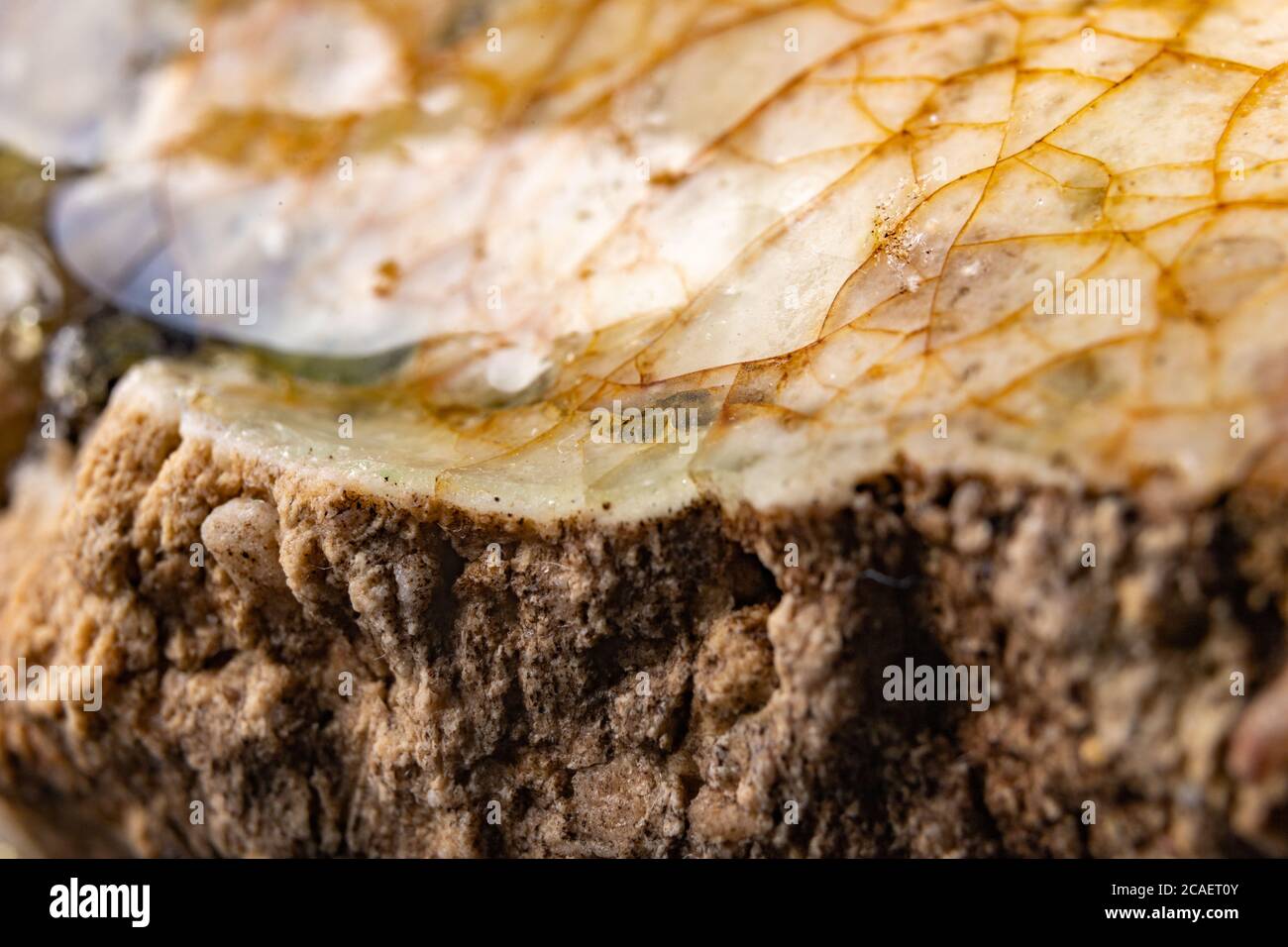 Partially molten quartz. Dirty vitrified glass material. Dark ...