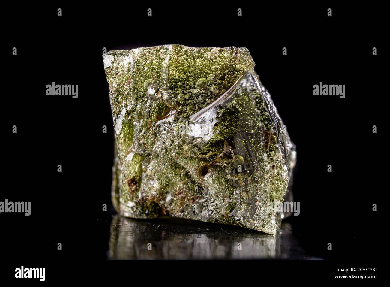 A piece of dark molten quartz with air bubbles. Melted sand in a glass ...