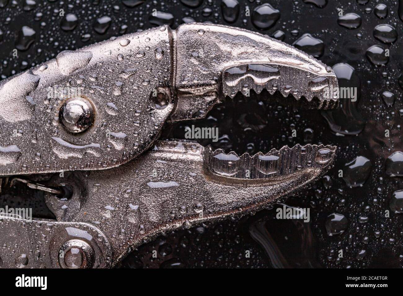 Adjustable hydraulic pipe wrench covered with water. Accessories for ...