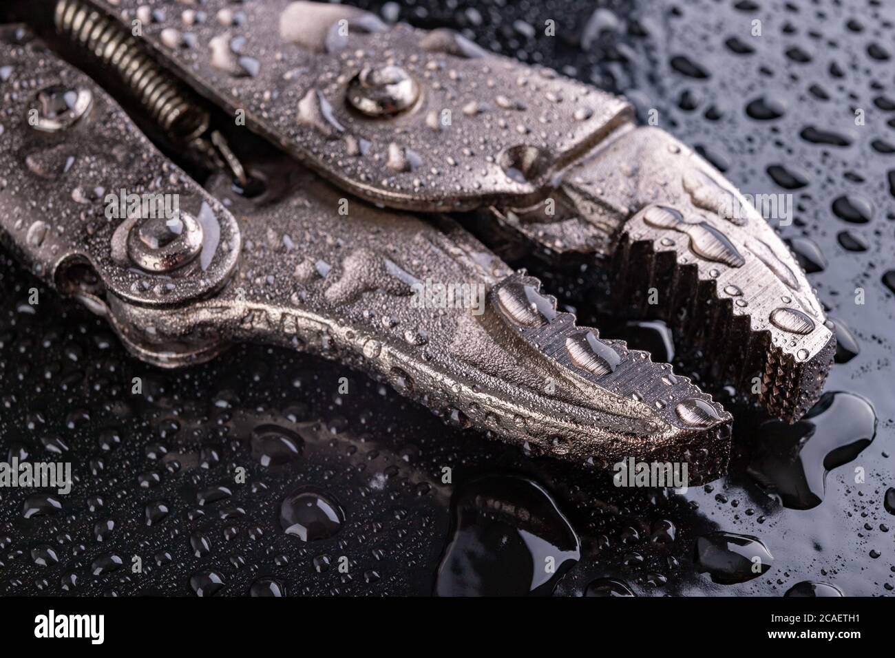 Adjustable hydraulic pipe wrench covered with water. Accessories for ...