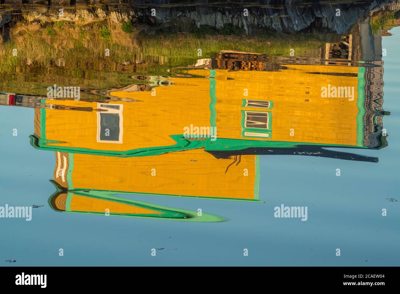 House in the village reflected in the harbour, Margaree, Newfoundland ...