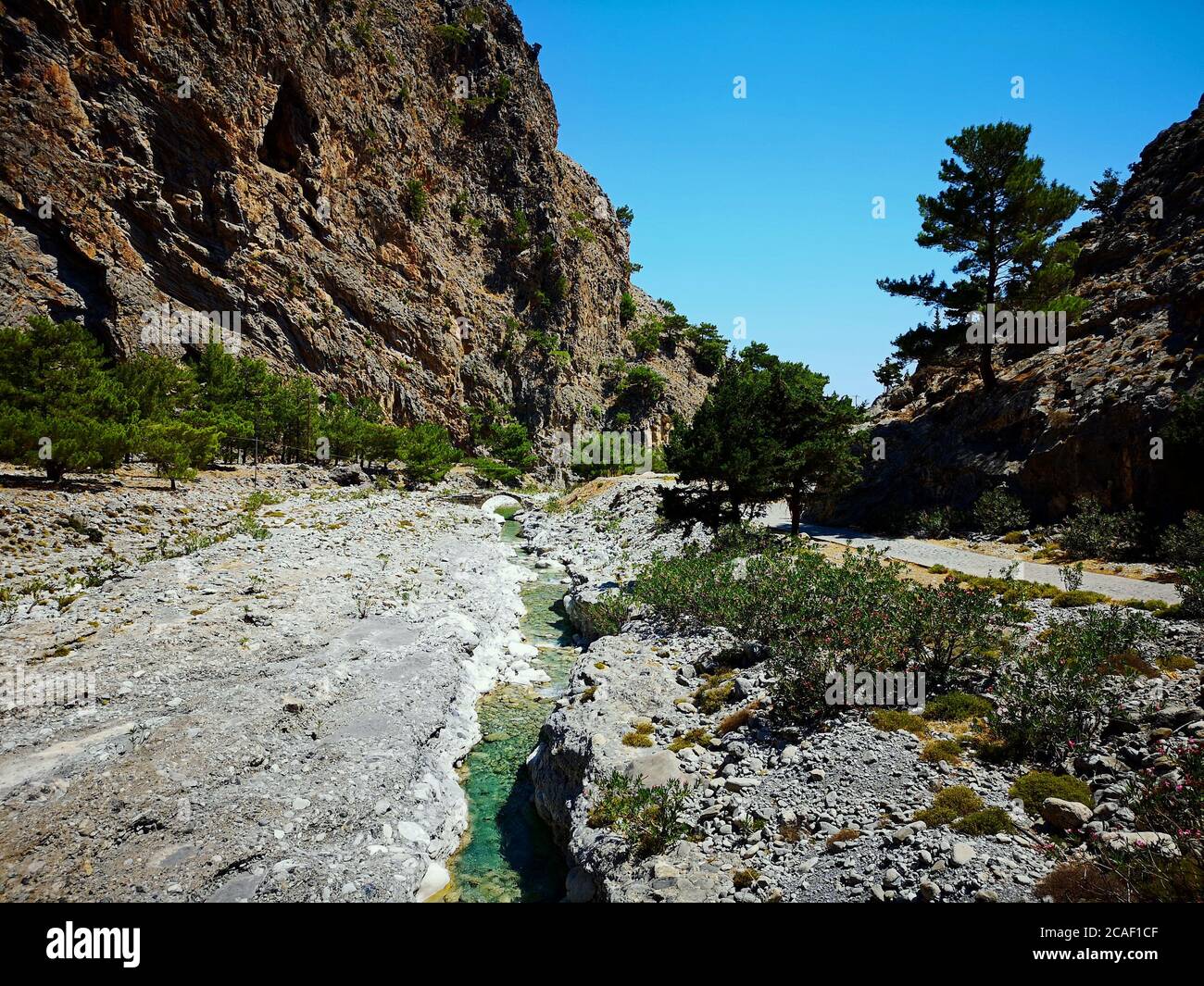 A low lying river running by a large cliff side in Crete Stock Photo ...