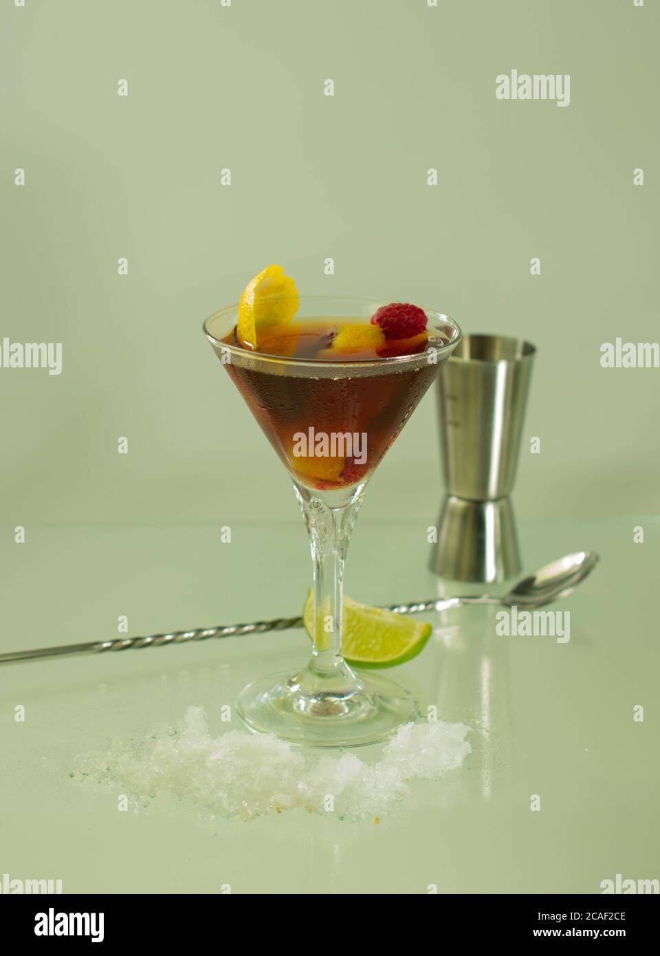 Vertical shot of an alcoholic cocktail on a light green surface Stock ...