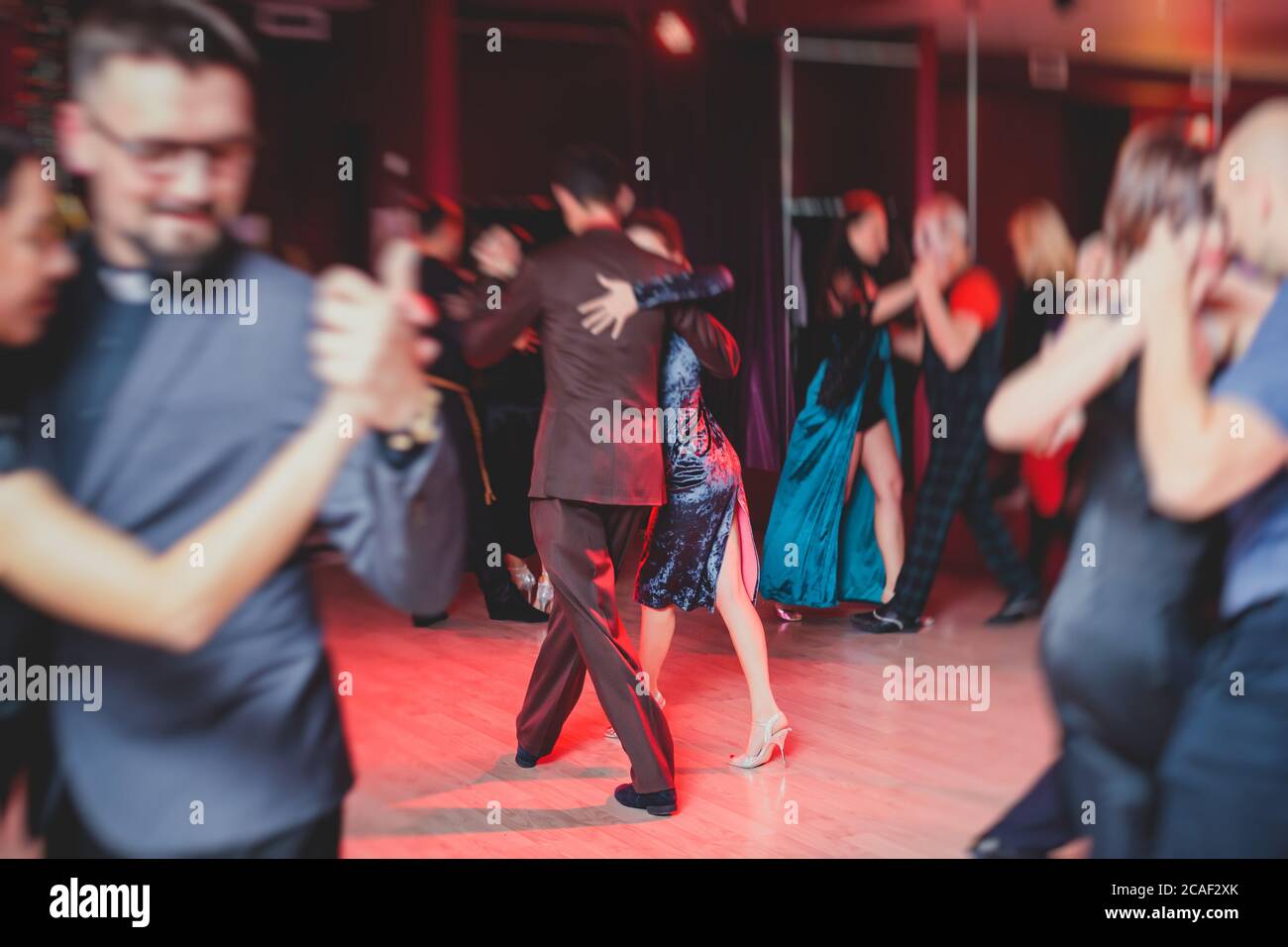 Couples dancing argentinian dance milonga in the ballroom, tango lesson ...