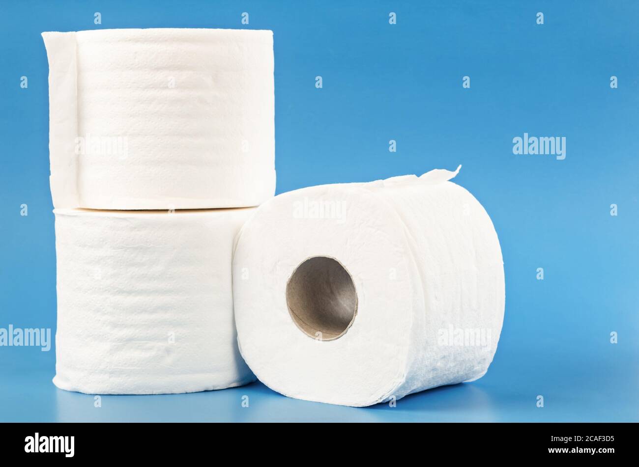 Tissue paper rolls on blue background Stock Photo - Alamy
