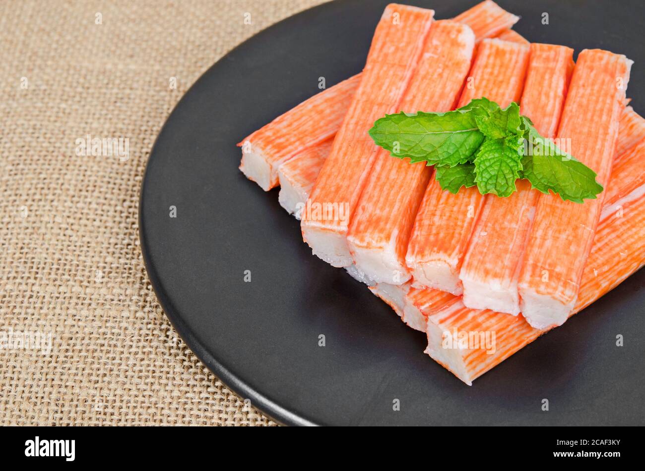 Imitation Crab Stick in black dish with green leaf Stock Photo - Alamy