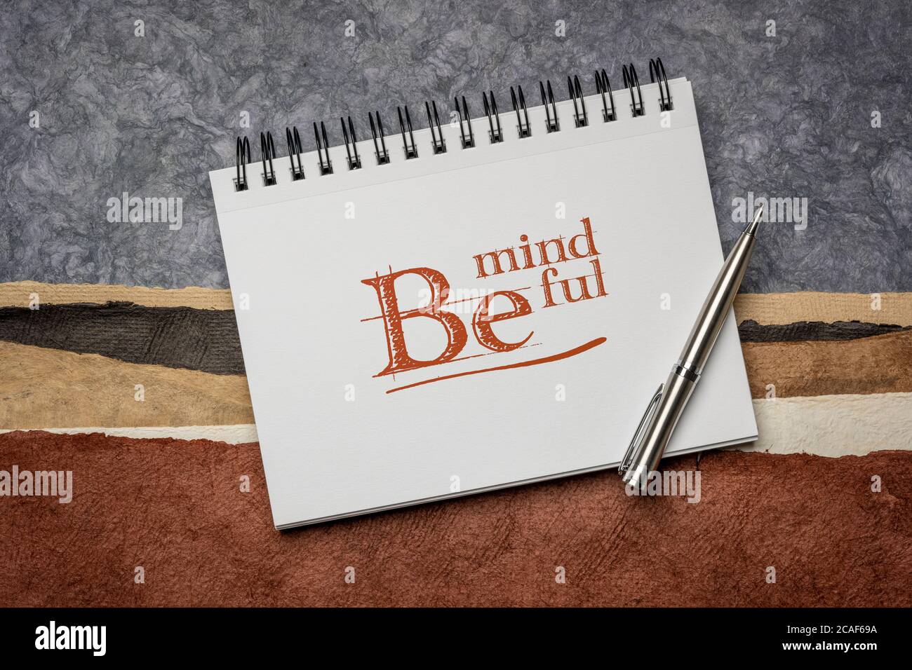 Be mindful - handwriting in an art sketchbook against abstract paper ...