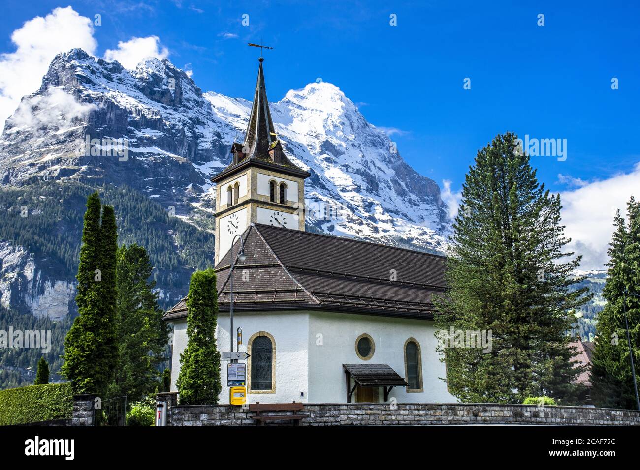 Beautiful show of a church with the snowy Alps in the background in ...