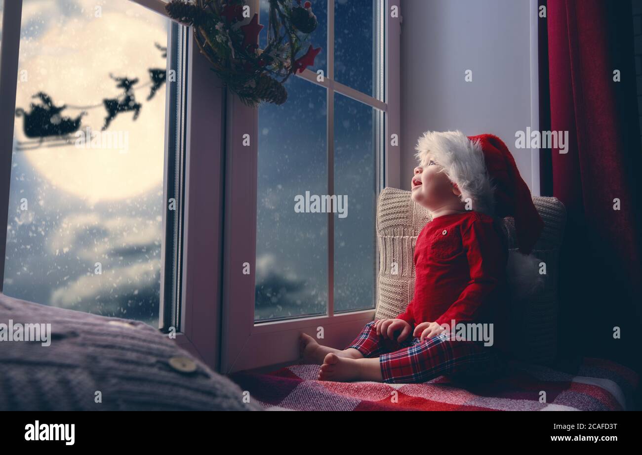 Merry Christmas and happy holidays! Cute little child baby girl sitting ...