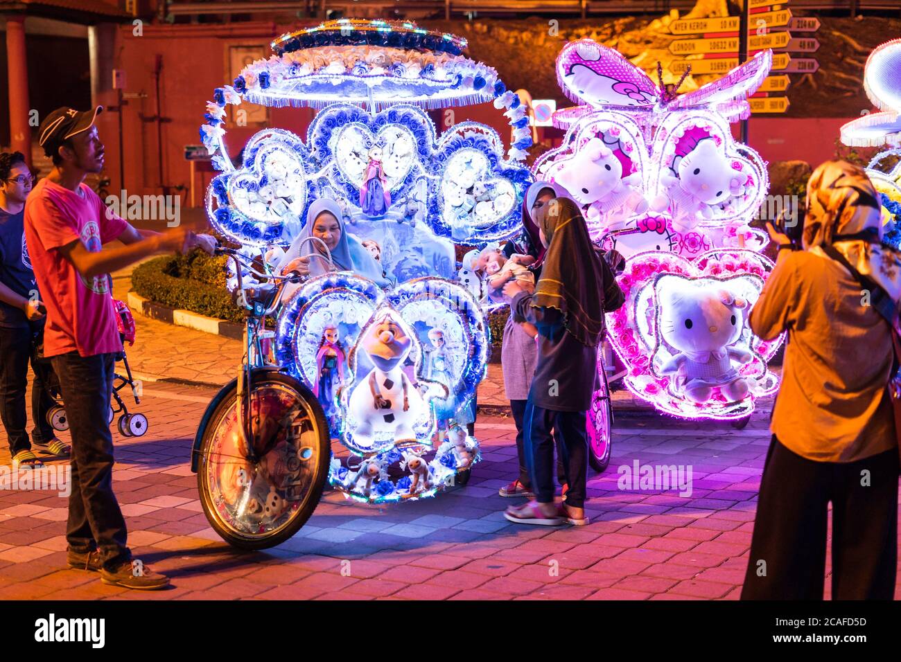 Malacca / Malaysia - February 16, 2019: Muslim women riding in rickshaw ...