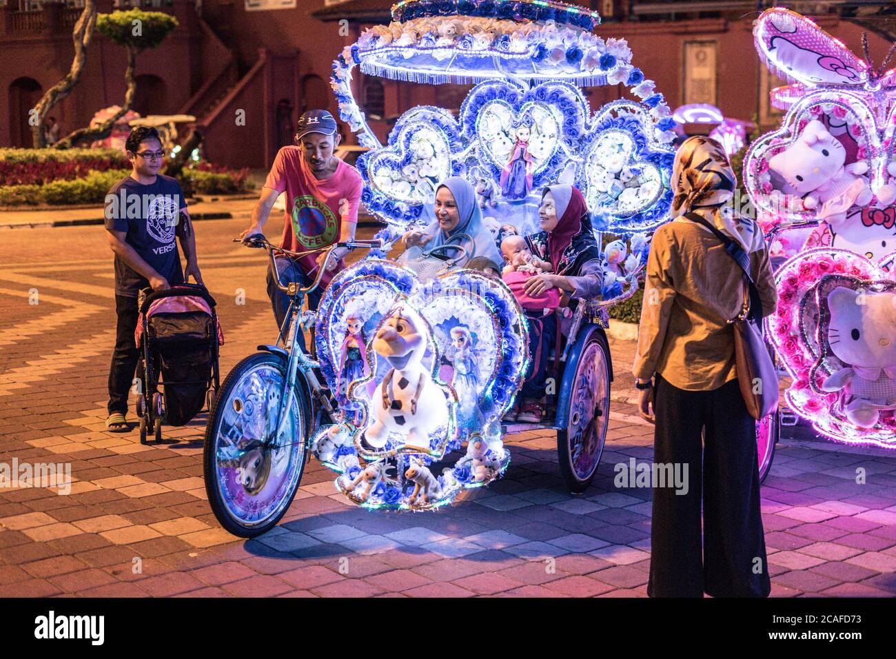 Malacca / Malaysia - February 16, 2019: Muslim women riding in rickshaw ...