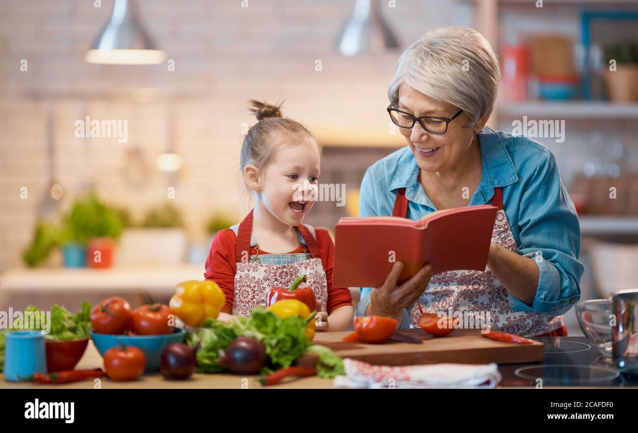 Healthy food at home. Happy family in the kitchen. Grandma and child ...