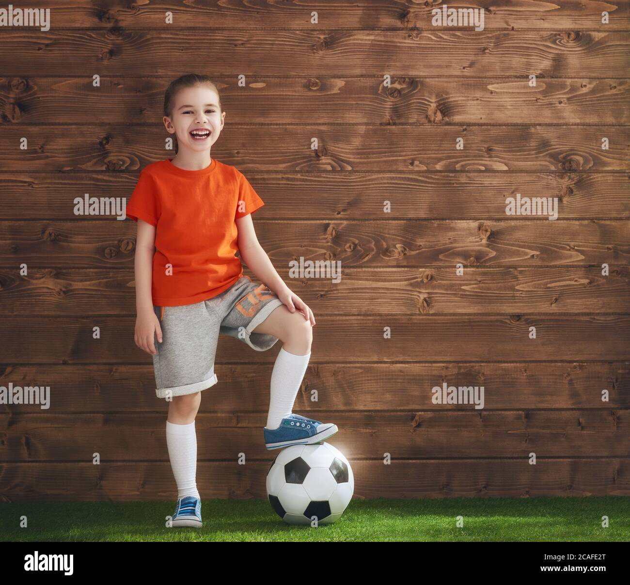 Cute little child dreams of becoming a soccer player. Girl plays ...