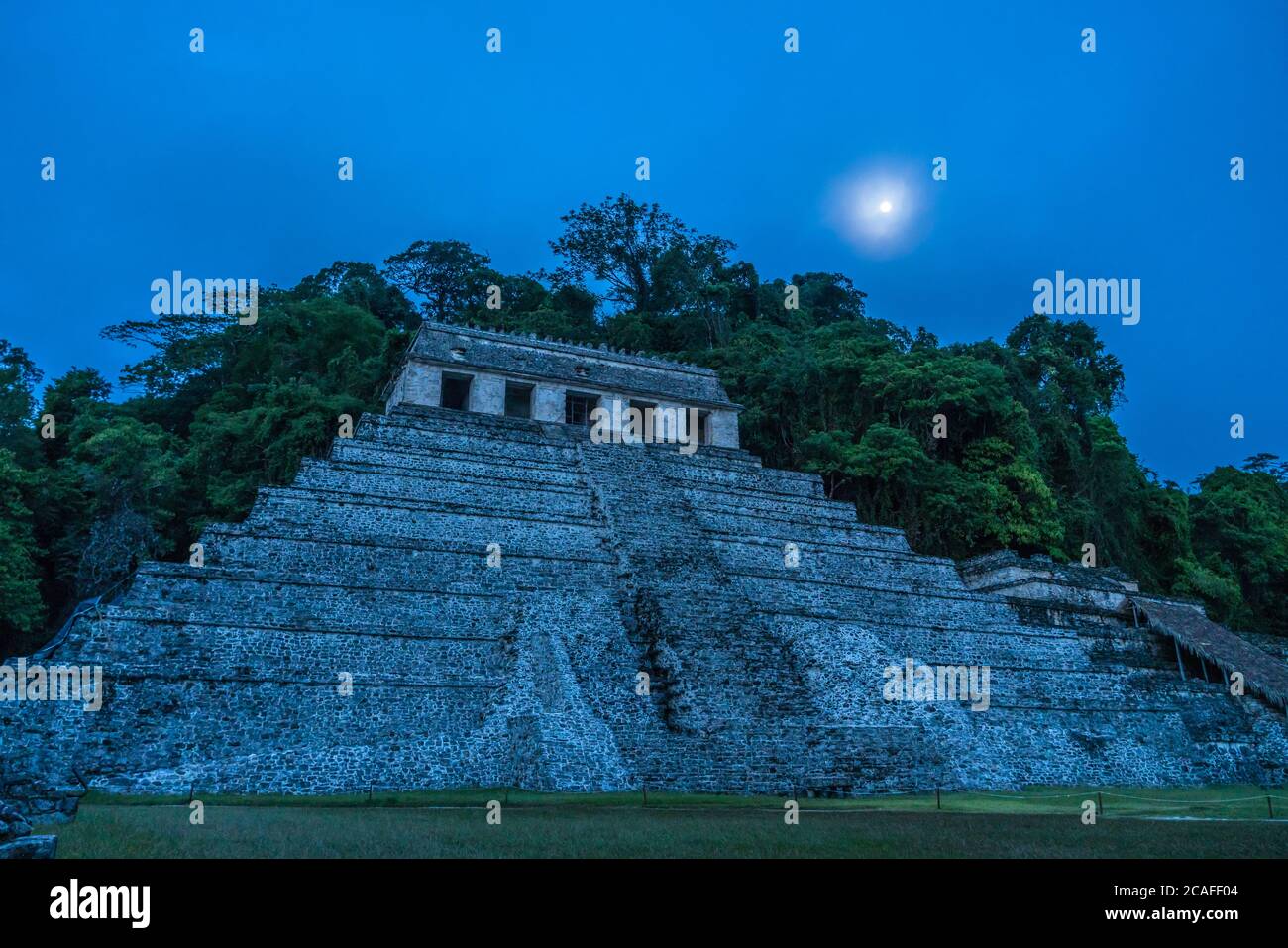The Temple of the Inscriptions with the moon before dawn in the ruins ...