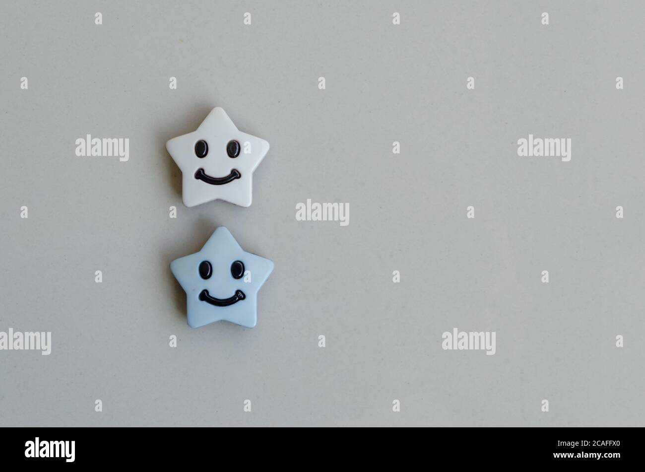 Star fridge magnets with smiling faces on a gray surface Stock Photo ...