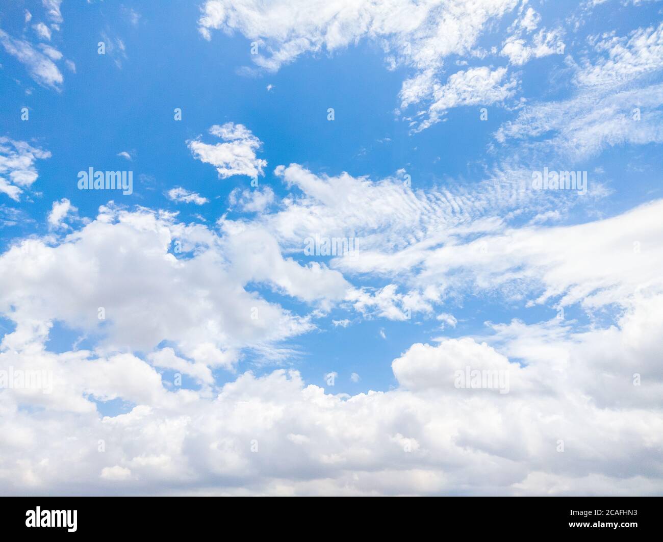 Blue sky and many white big clouds in daylight. Natural sky composition ...