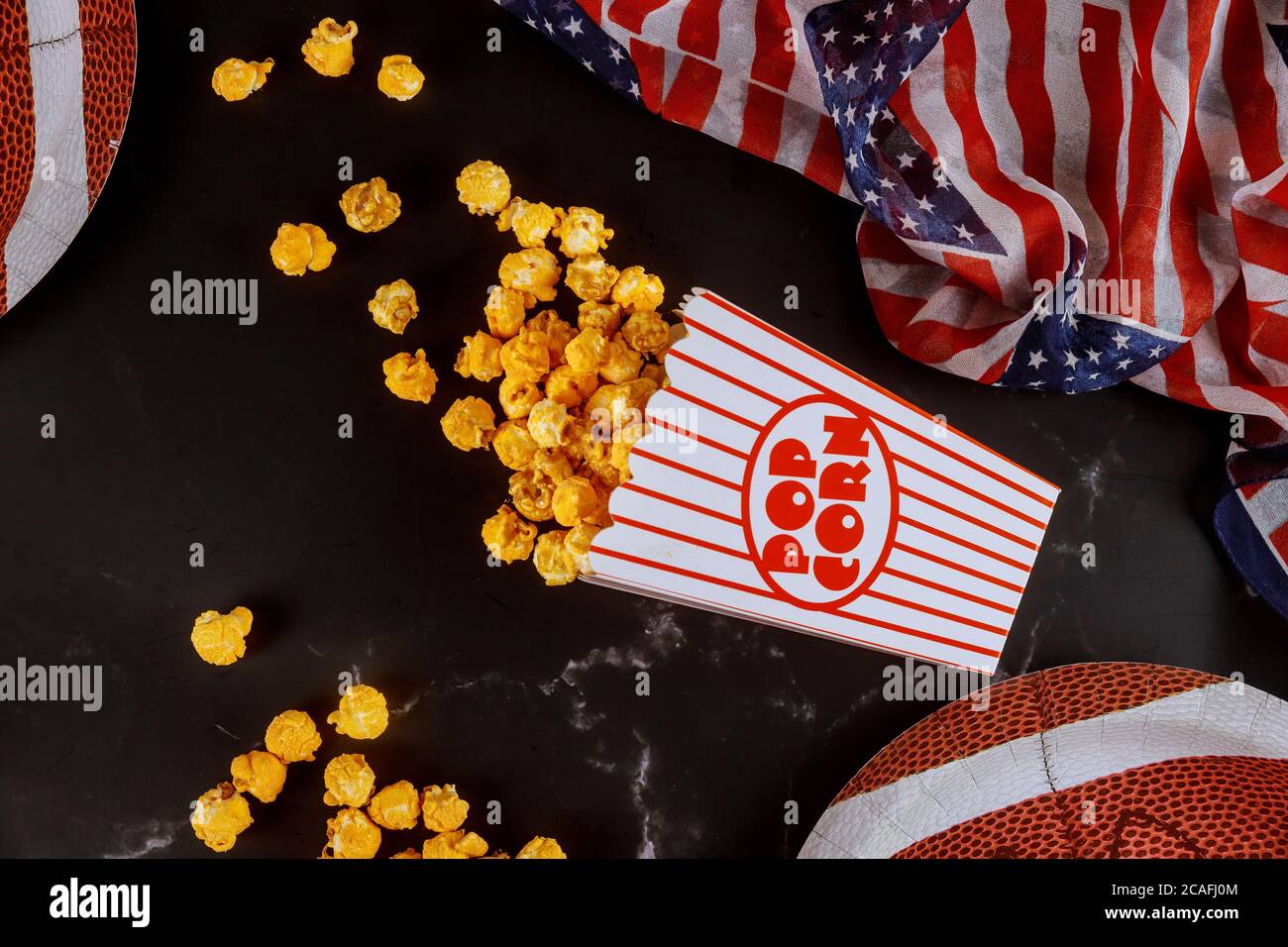 Caramel popcorn in striped box for watching american football game on ...