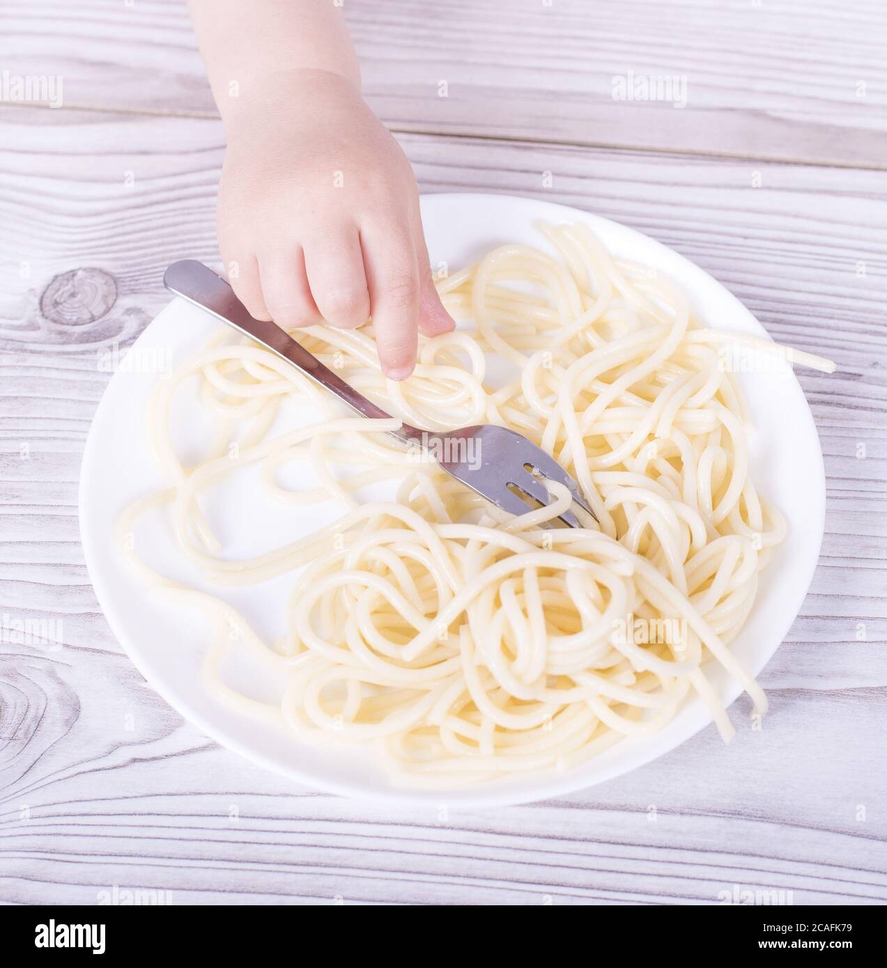 Child touching the delicious spaghetti on the plate Stock Photo - Alamy