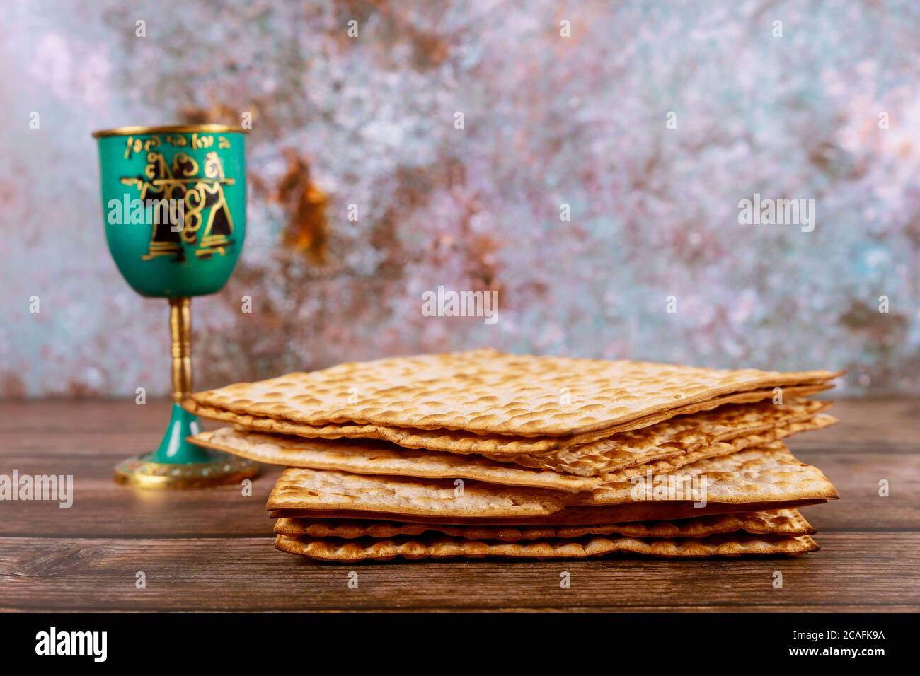 Jewish holiday table for Passover with matzah and metalic cup of kosher ...