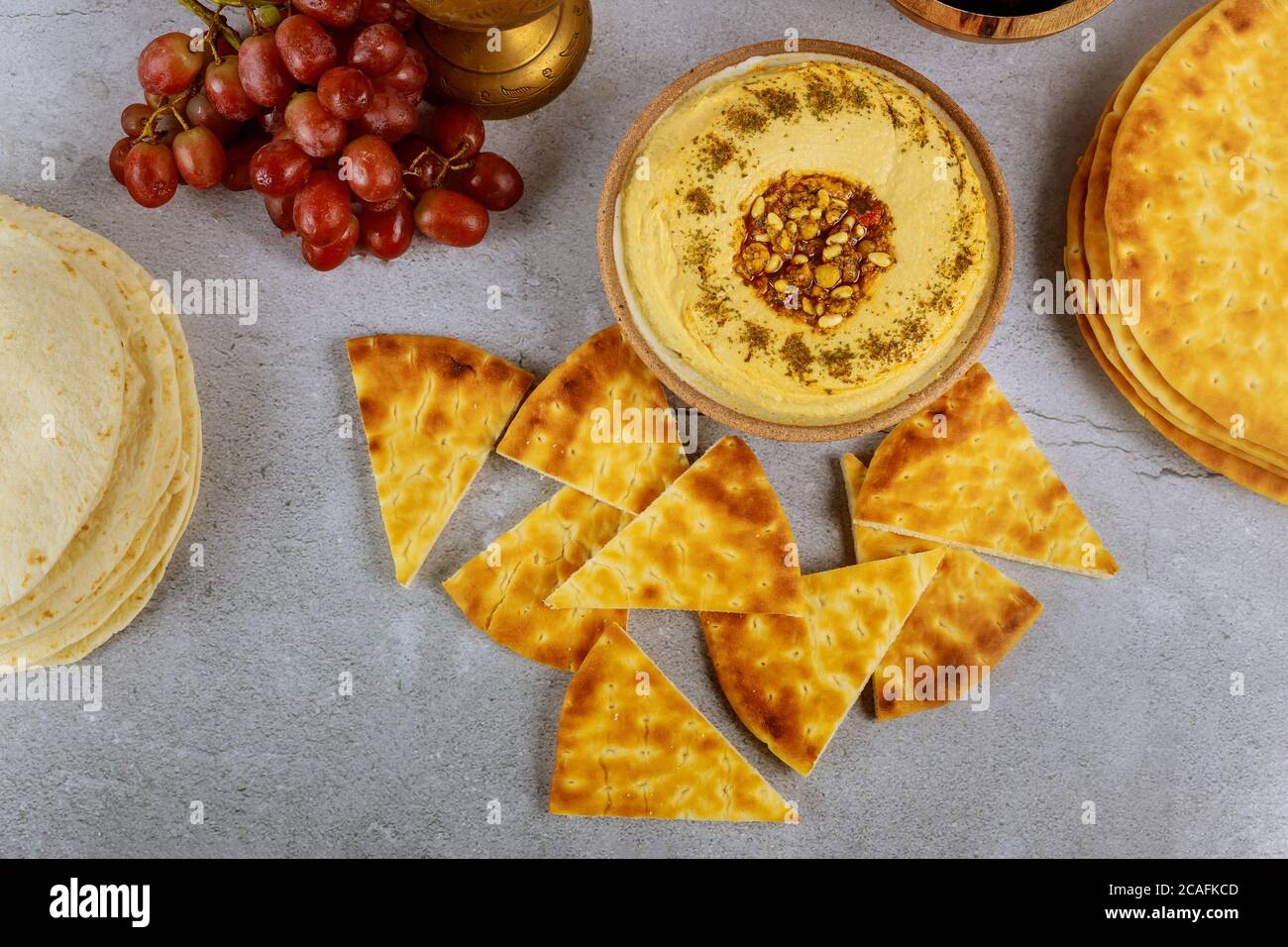 Arabian dinner table with pita bread, hummus and grapes on white ...