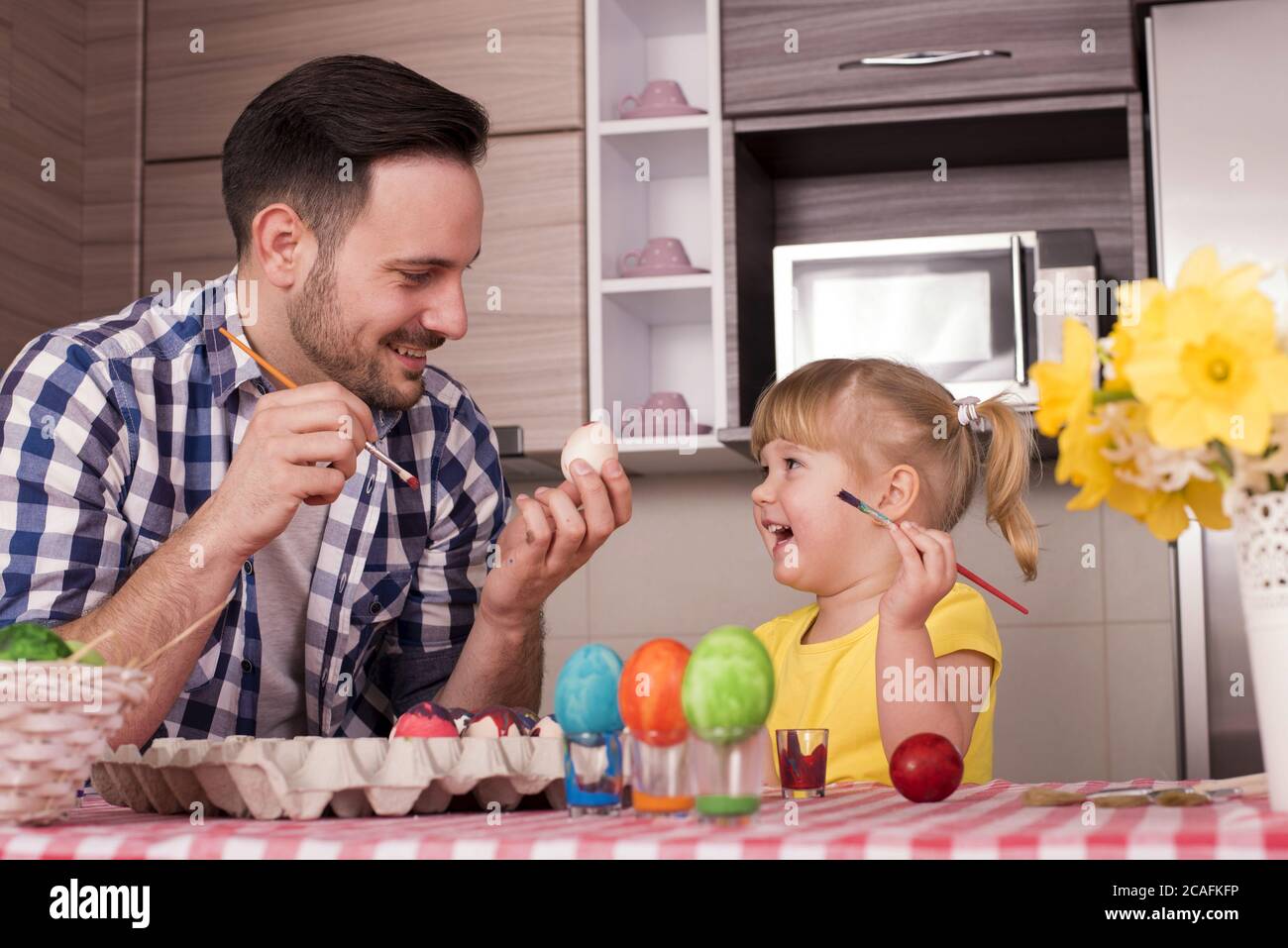 Father and his little child painting the easter eggs Stock Photo - Alamy