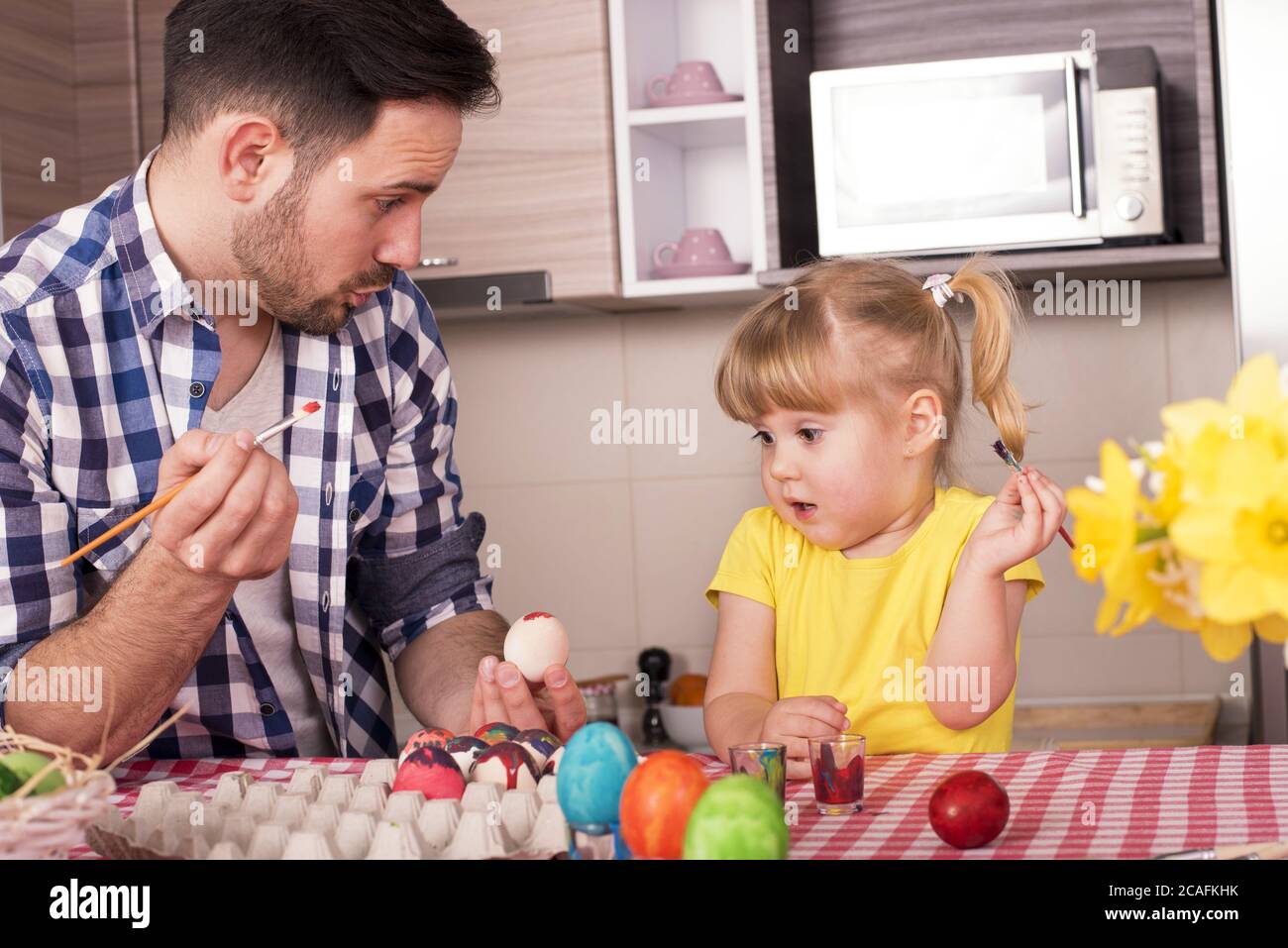 Father and his little child painting the easter eggs Stock Photo - Alamy