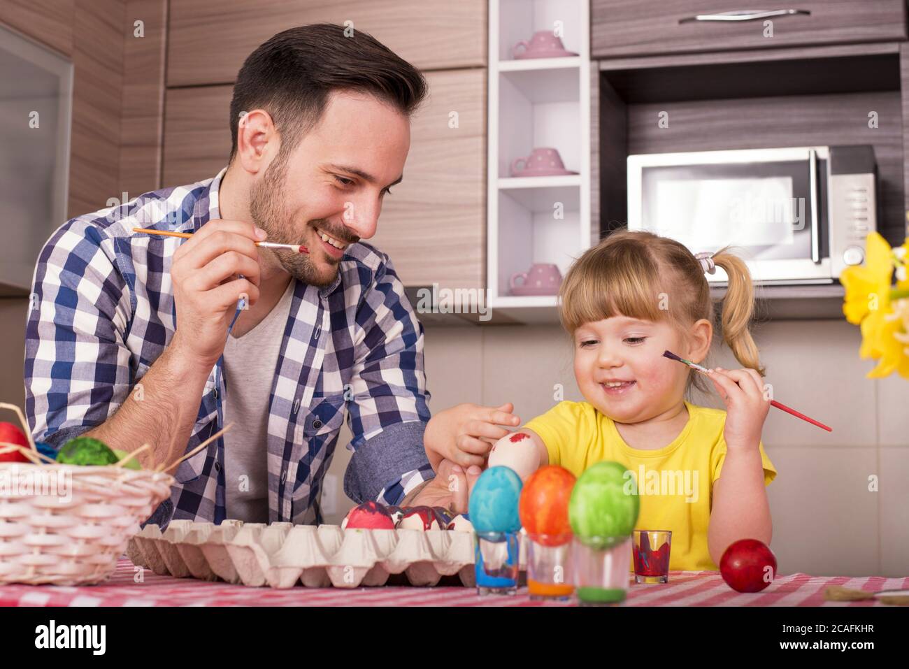Father and his little child painting the easter eggs Stock Photo - Alamy