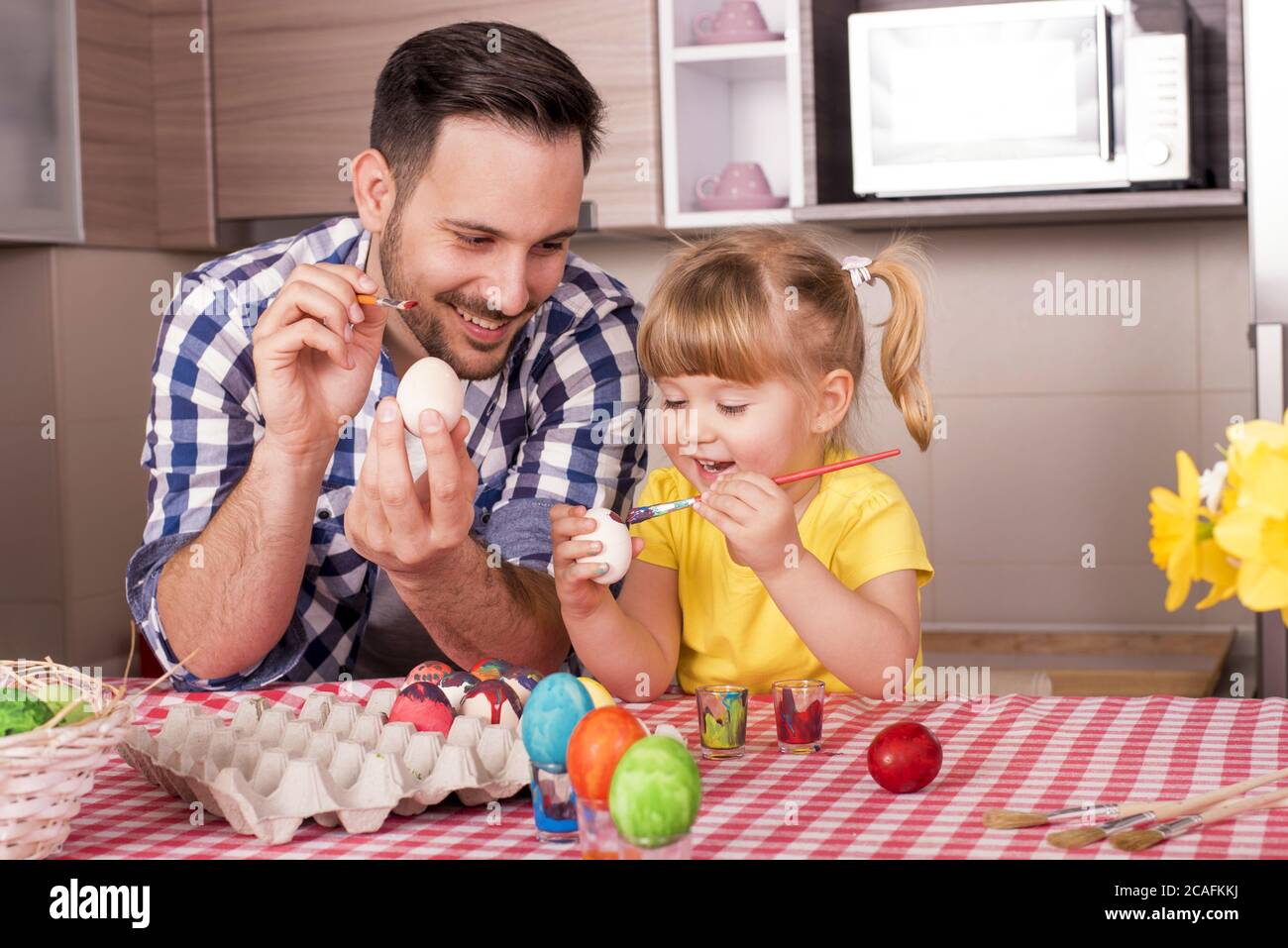Father and his little child painting the easter eggs Stock Photo - Alamy
